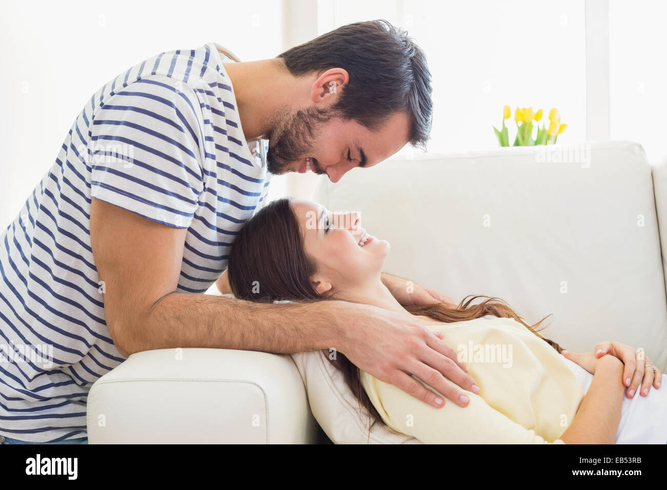 Cute couple relaxing on couch Stock Photo - Alamy