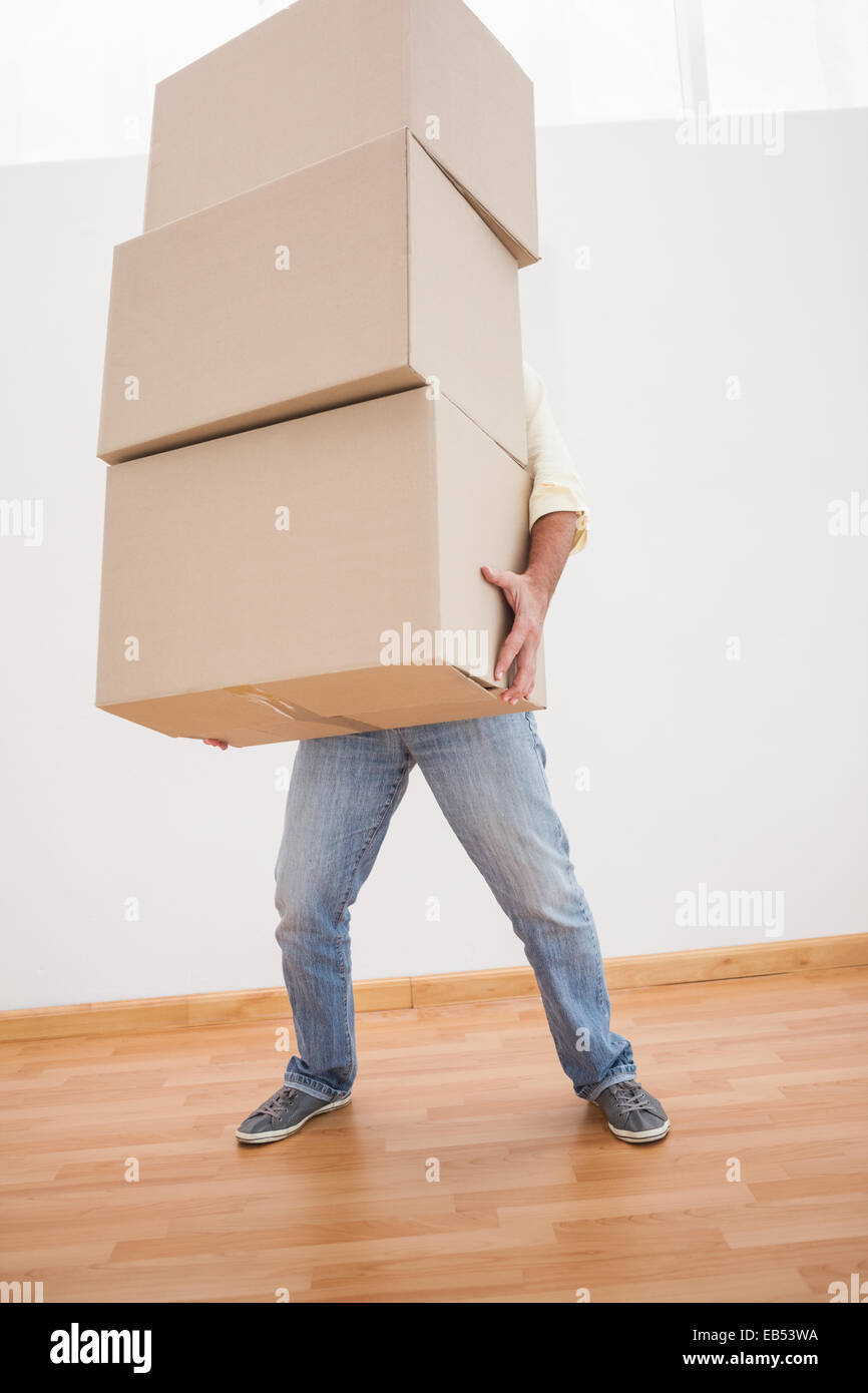Man balancing heavy cardboard boxes Stock Photo - Alamy