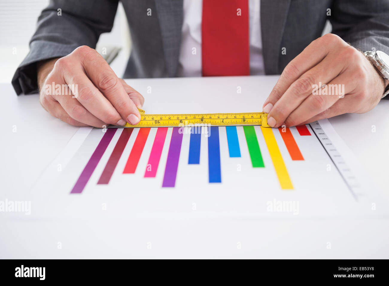 Businessman measuring graph with tape Stock Photo - Alamy