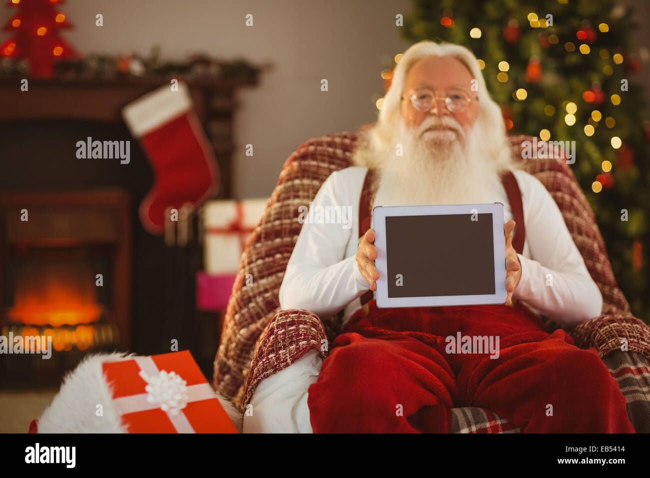 Santa claus showing tablets screen Stock Photo - Alamy
