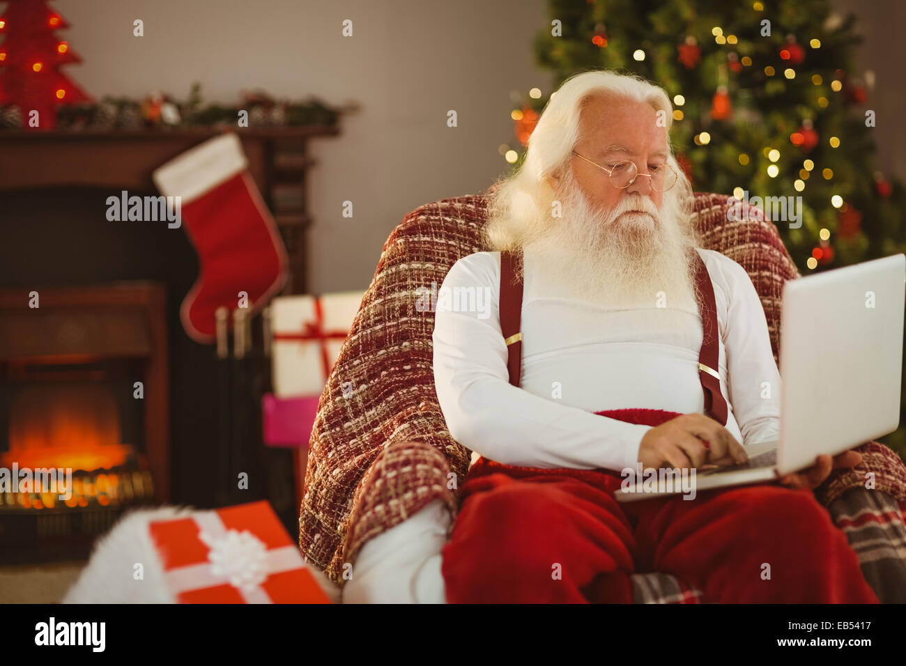 Santa claus typing on laptop Stock Photo - Alamy