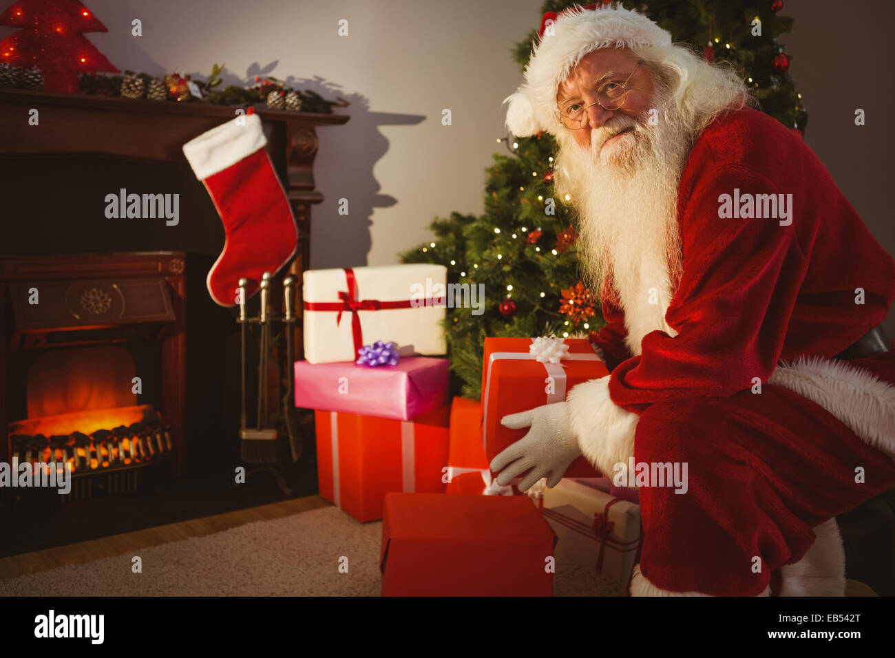 Smiling santa delivering gifts hi-res stock photography and images - Alamy