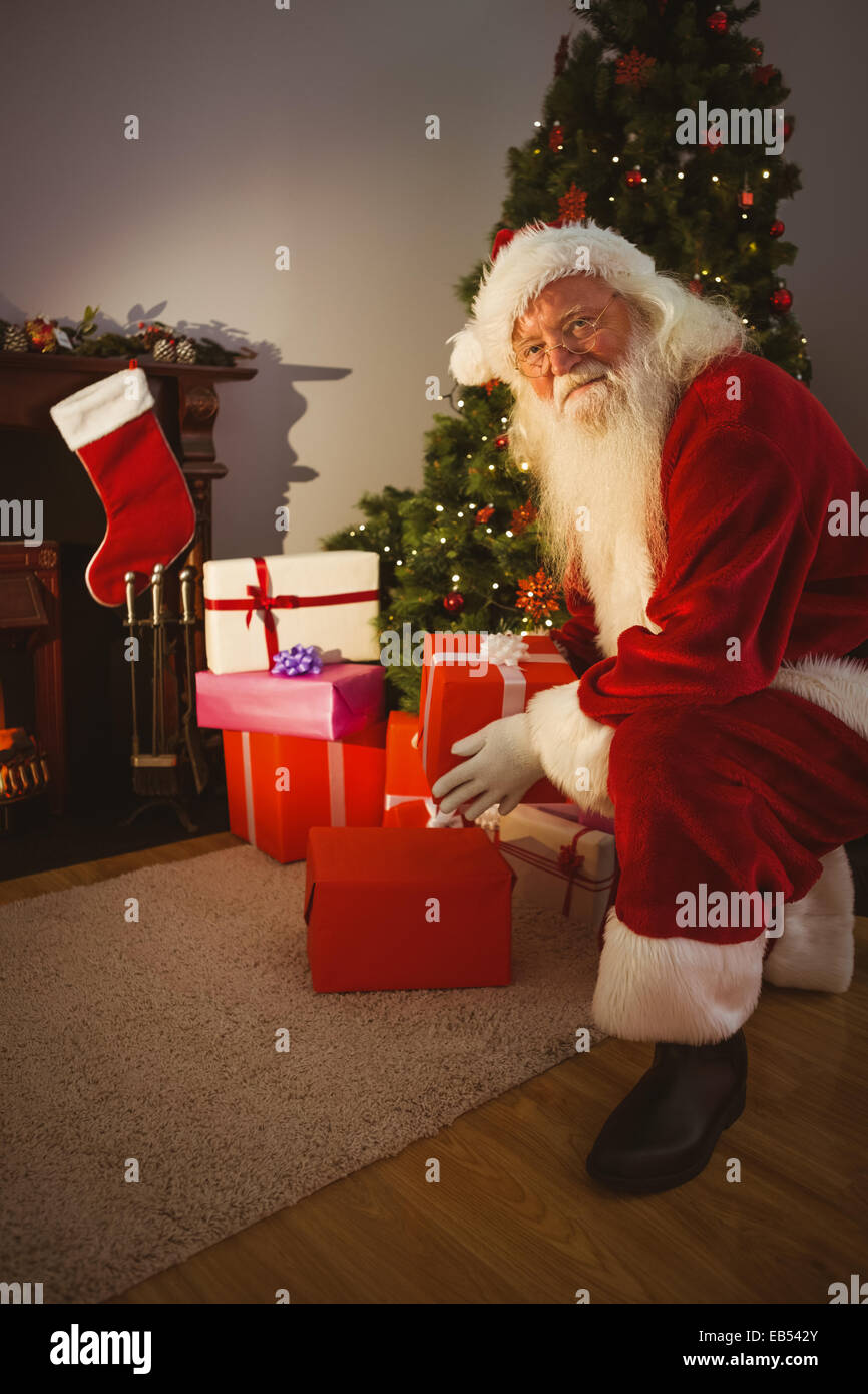Happy santa delivering gifts at christmas eve Stock Photo - Alamy