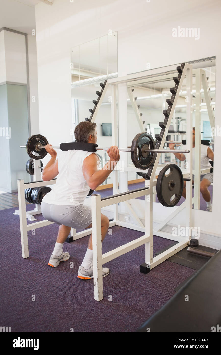 Fit man lifting heavy barbell Stock Photo - Alamy