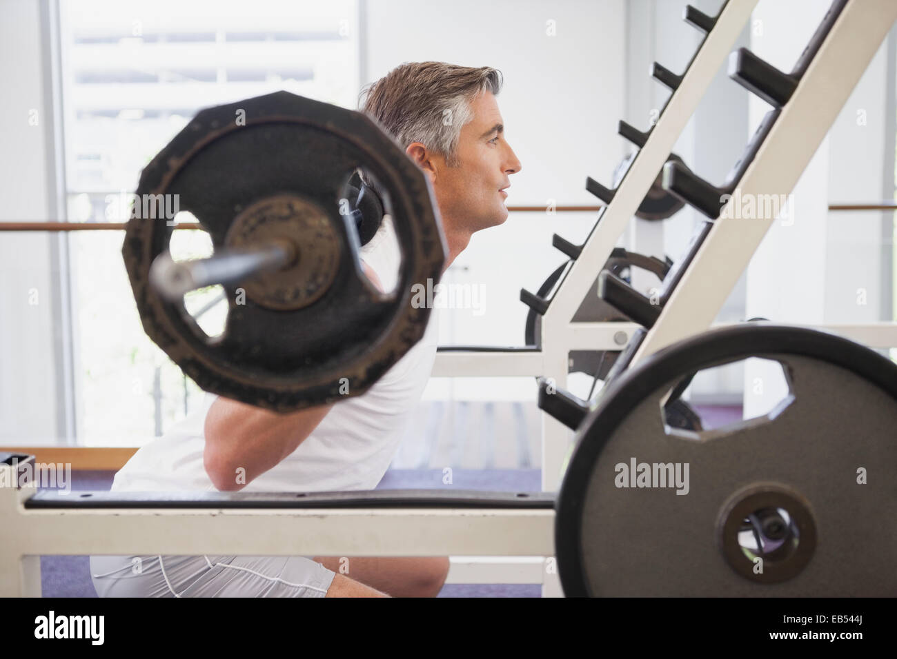 Fit man lifting heavy barbell Stock Photo - Alamy