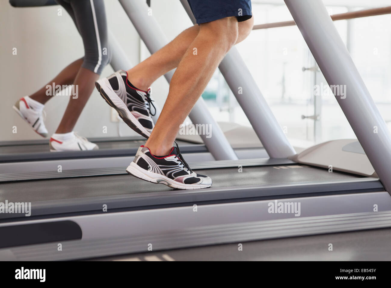 Fit people running on treadmills Stock Photo - Alamy