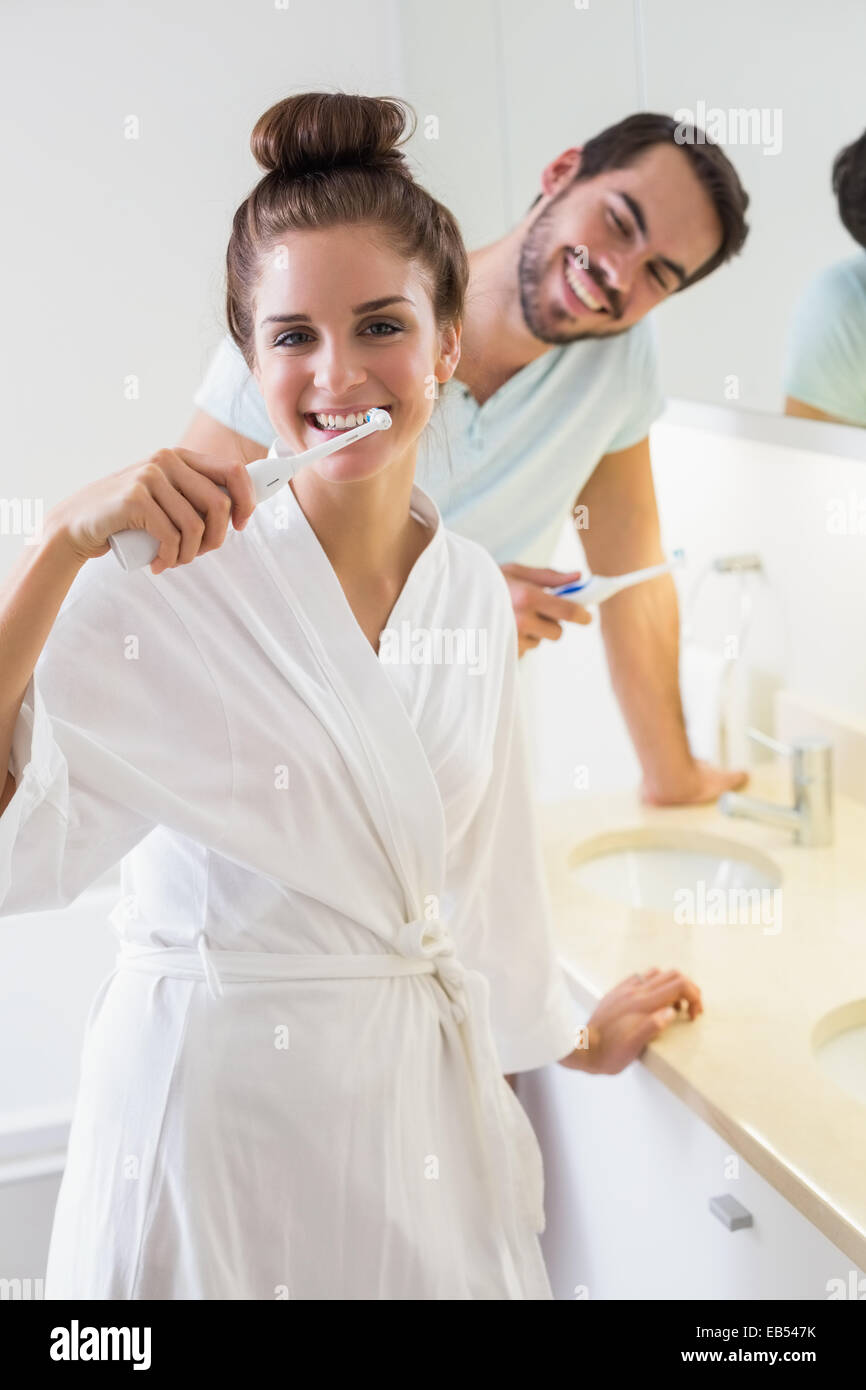 Young couple brushing their teeth Stock Photo - Alamy