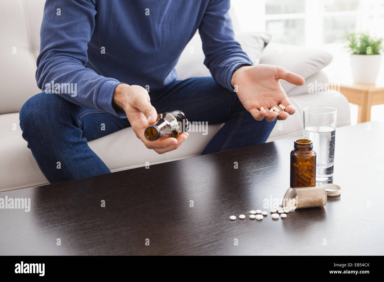 Man with his medicine laid out on coffee table Stock Photo - Alamy