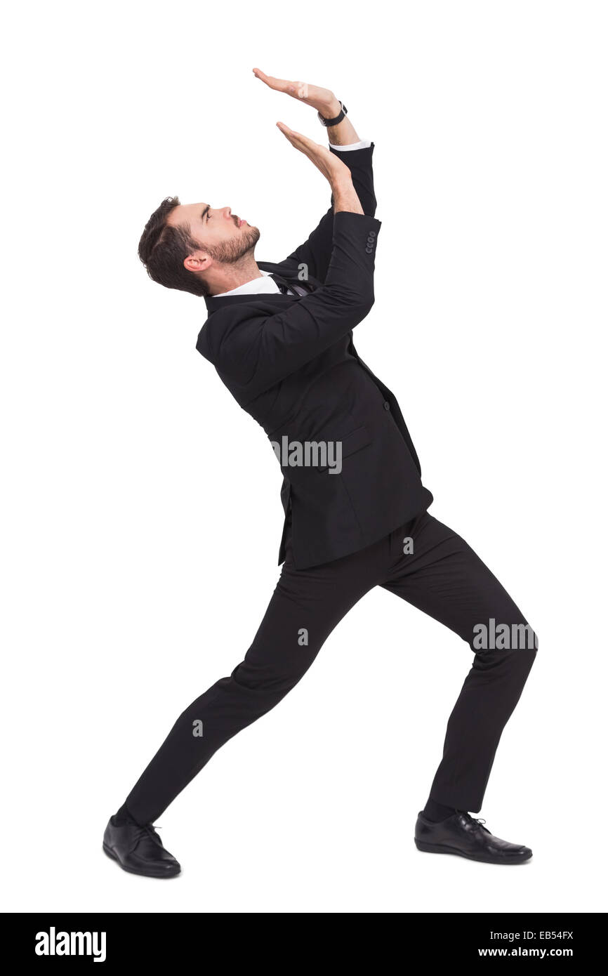 Focused businessman pushing with hands Stock Photo - Alamy