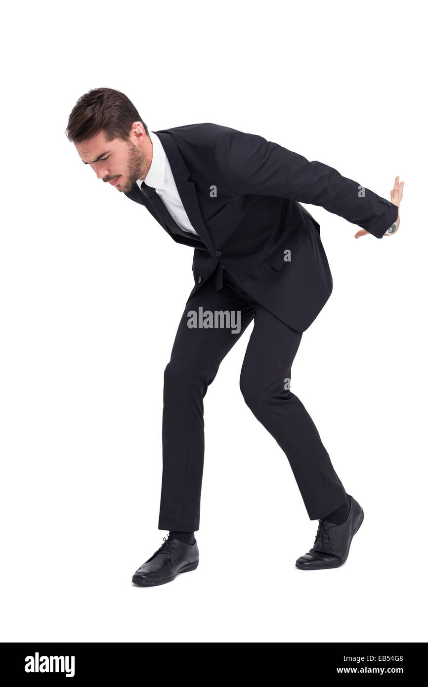Businessman carrying something heavy with his back and hands Stock ...