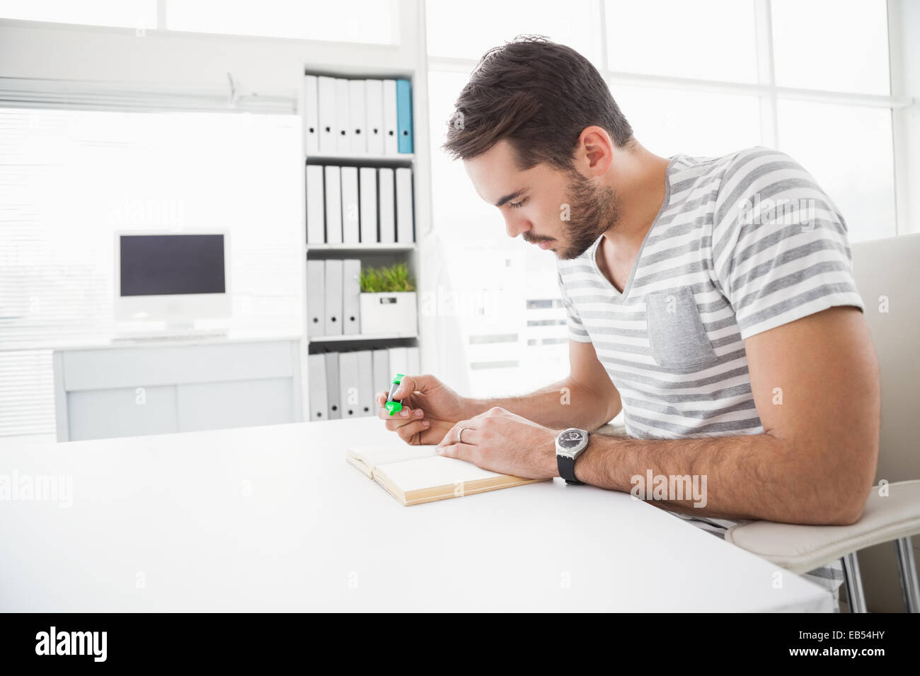 Young professional highlighting book hi-res stock photography and ...