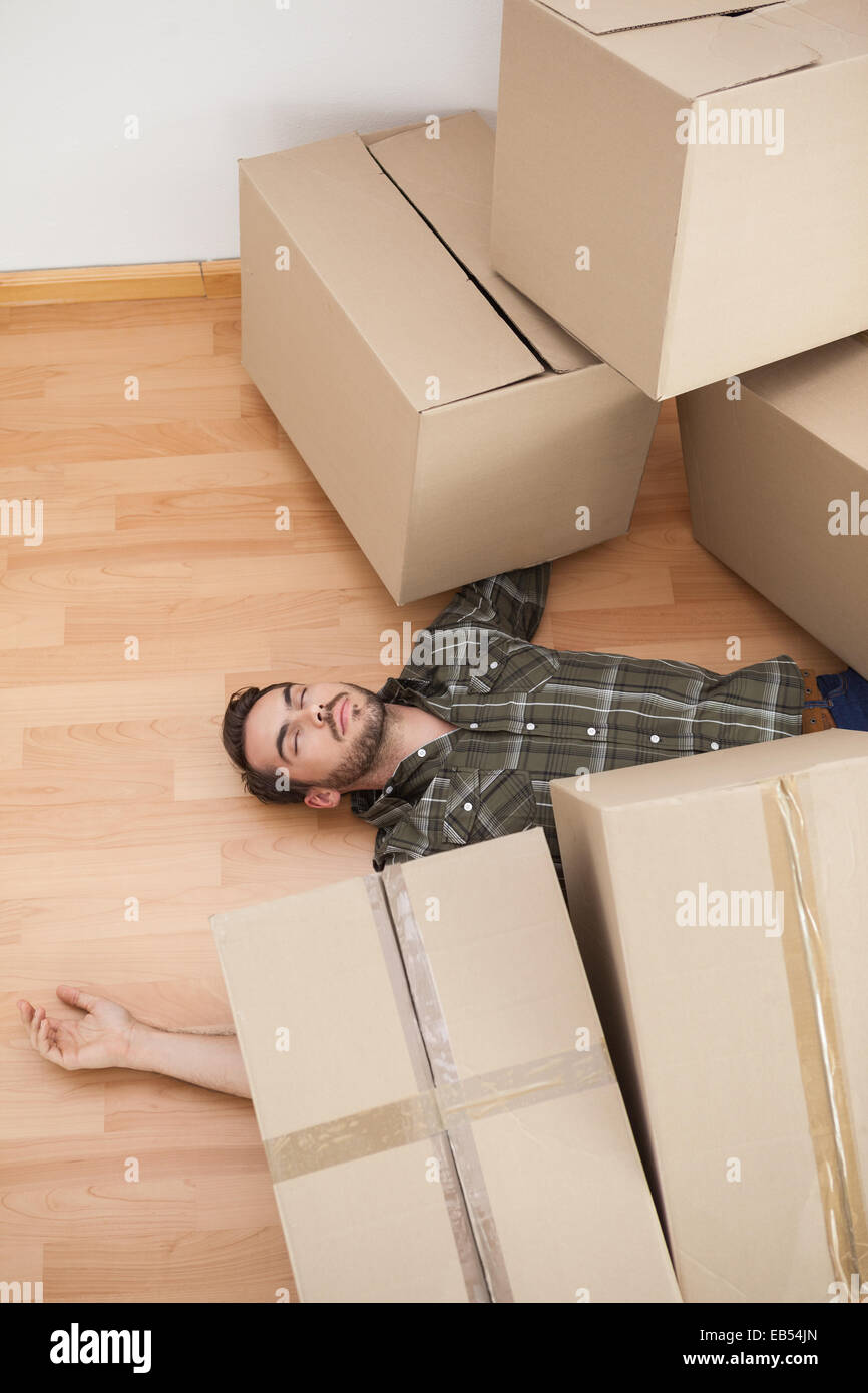 Man lying under fallen boxes hi-res stock photography and images - Alamy