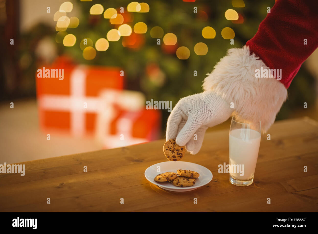 Hand of santa claus picking cookie Stock Photo - Alamy
