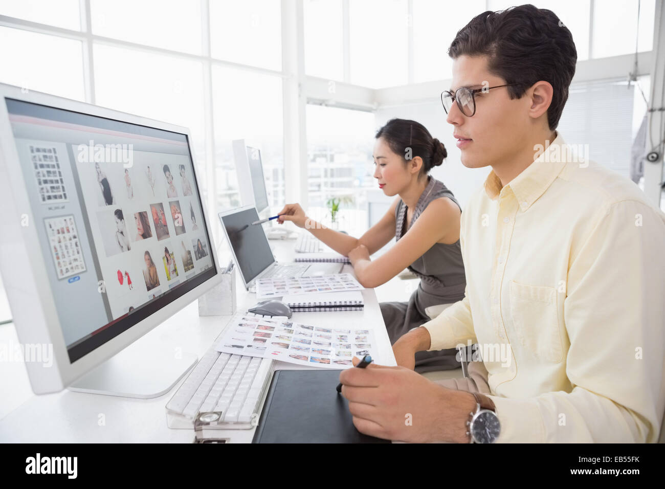Creative team working at desk Stock Photo - Alamy