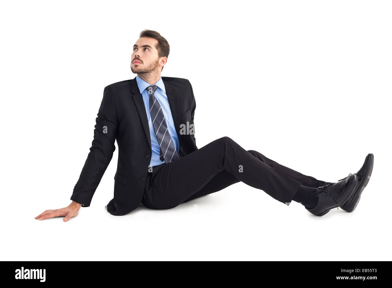 Businessman sitting on floor looking up Stock Photo - Alamy