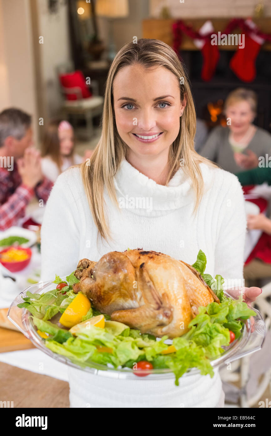 Portrait of a smiling woman showing the roast turkey Stock Photo - Alamy