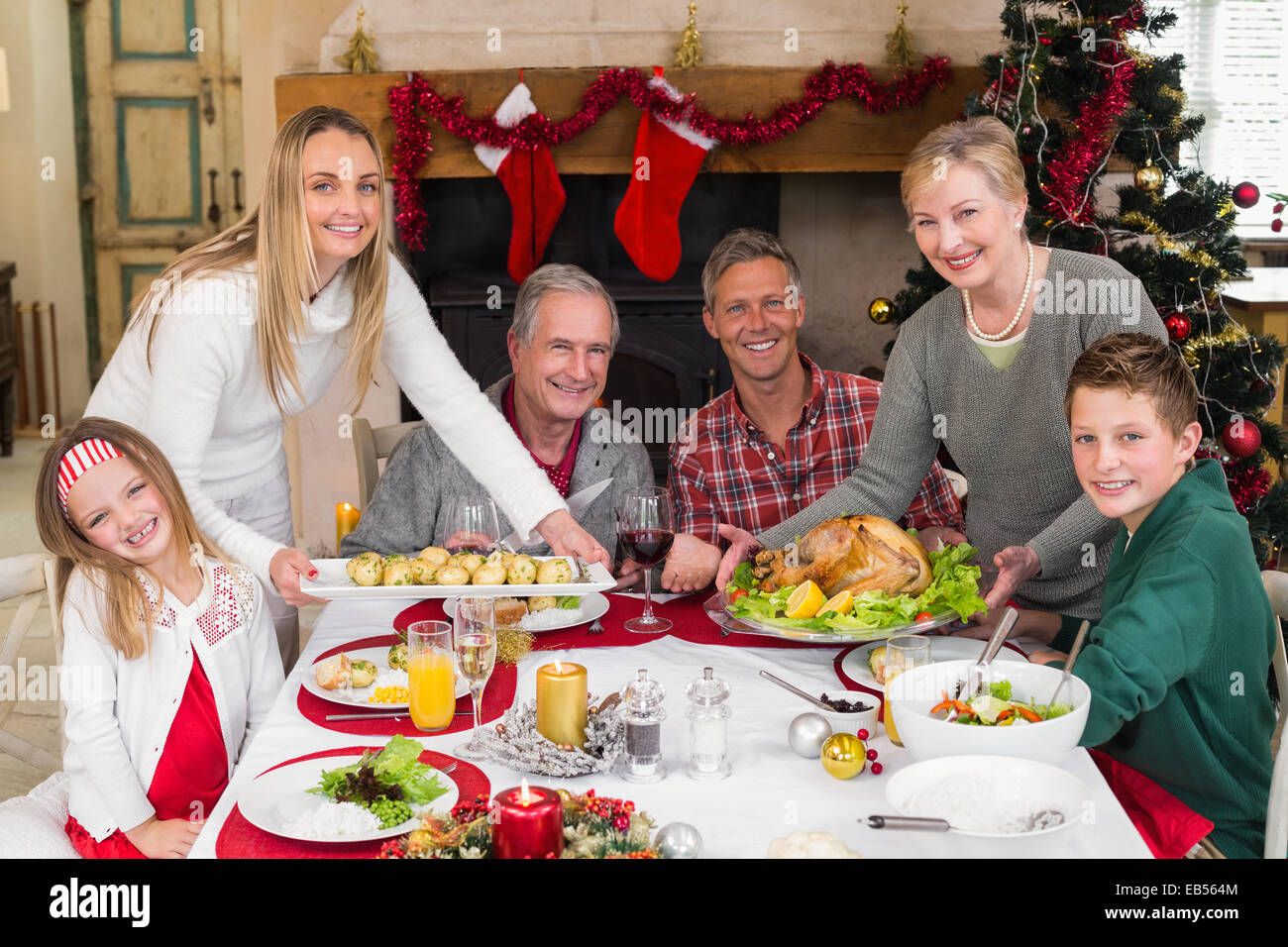 Two women serving christmas dinner to their family Stock Photo - Alamy