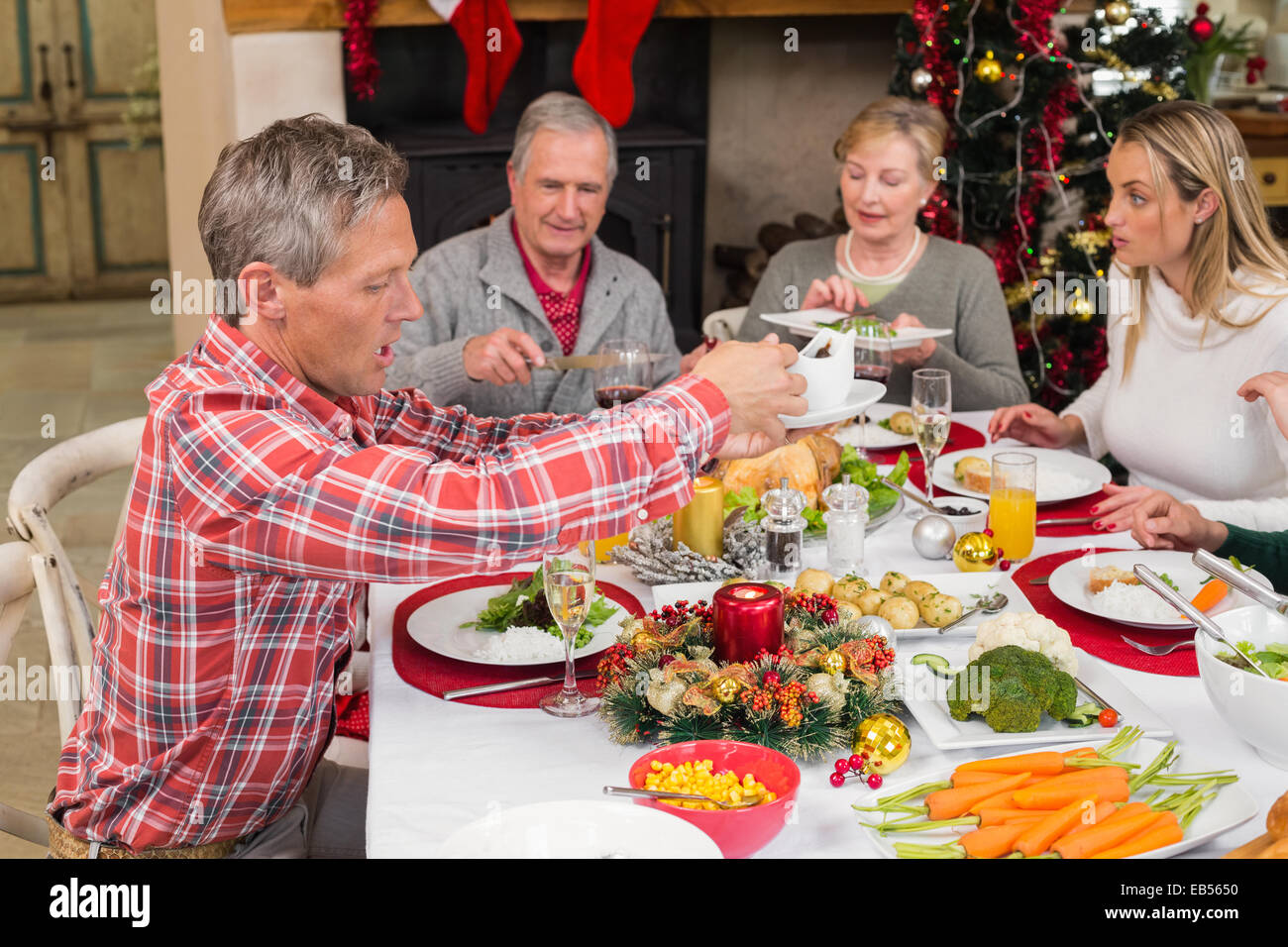 Three generation family having christmas dinner together Stock Photo ...