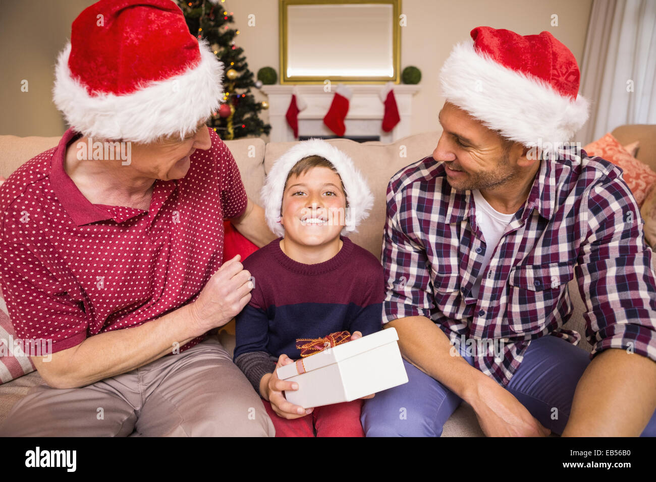 Three generation family celebrating christmas Stock Photo - Alamy