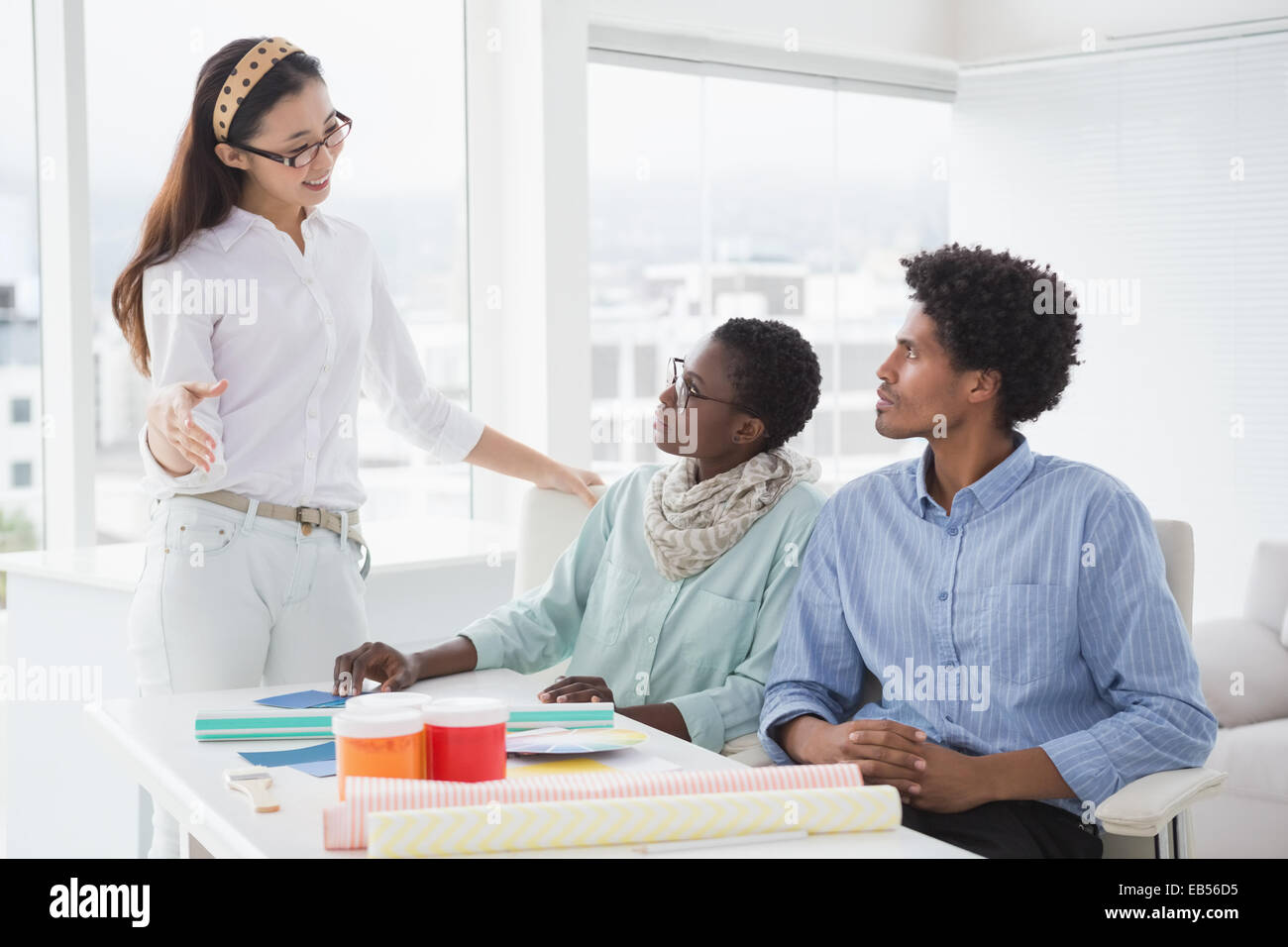 Interior designer speaking with clients Stock Photo - Alamy