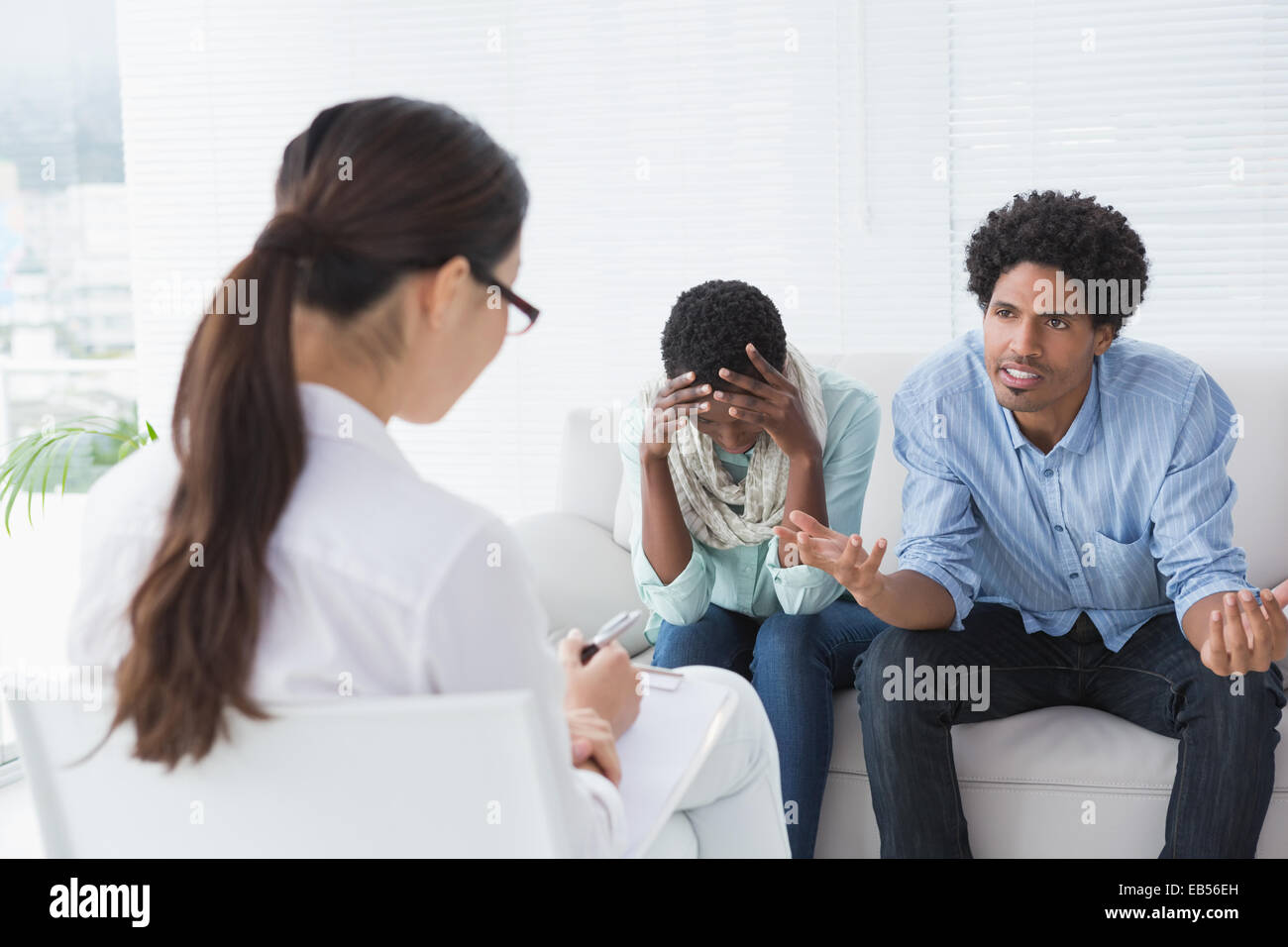 Angry couple talking to their therapist Stock Photo - Alamy