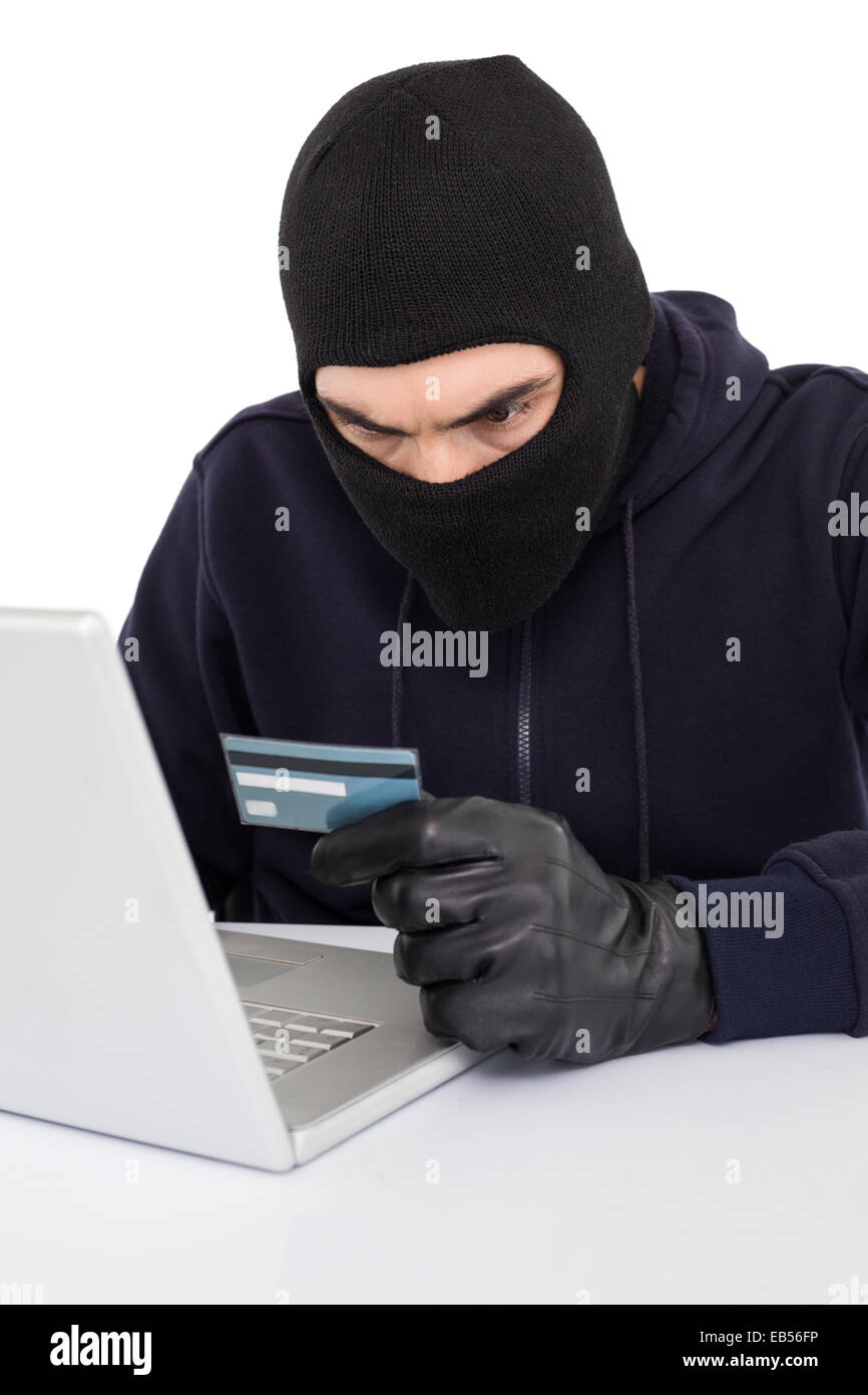Angry hacker using laptop and credit card Stock Photo - Alamy