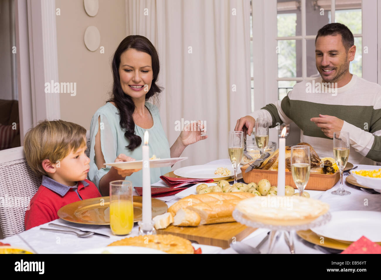 Woman passing roast turkey hi-res stock photography and images - Alamy