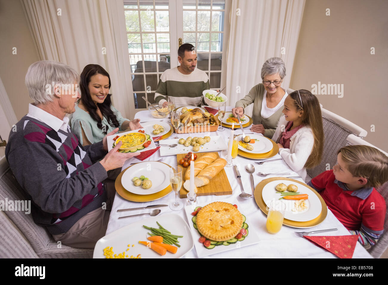 Three generation family having christmas dinner together Stock Photo ...