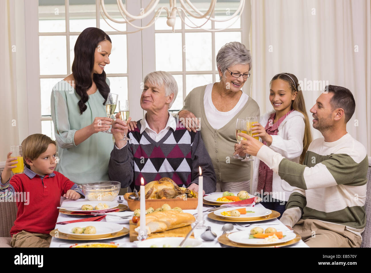 Family toasting with champagne in a christmas dinner Stock Photo - Alamy