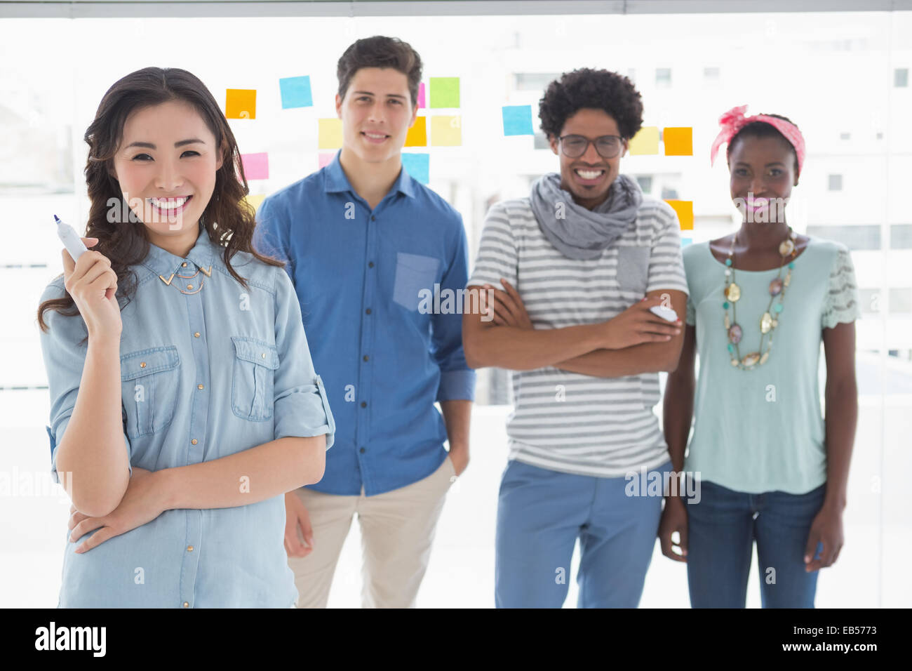 Young creative team smiling at camera Stock Photo - Alamy