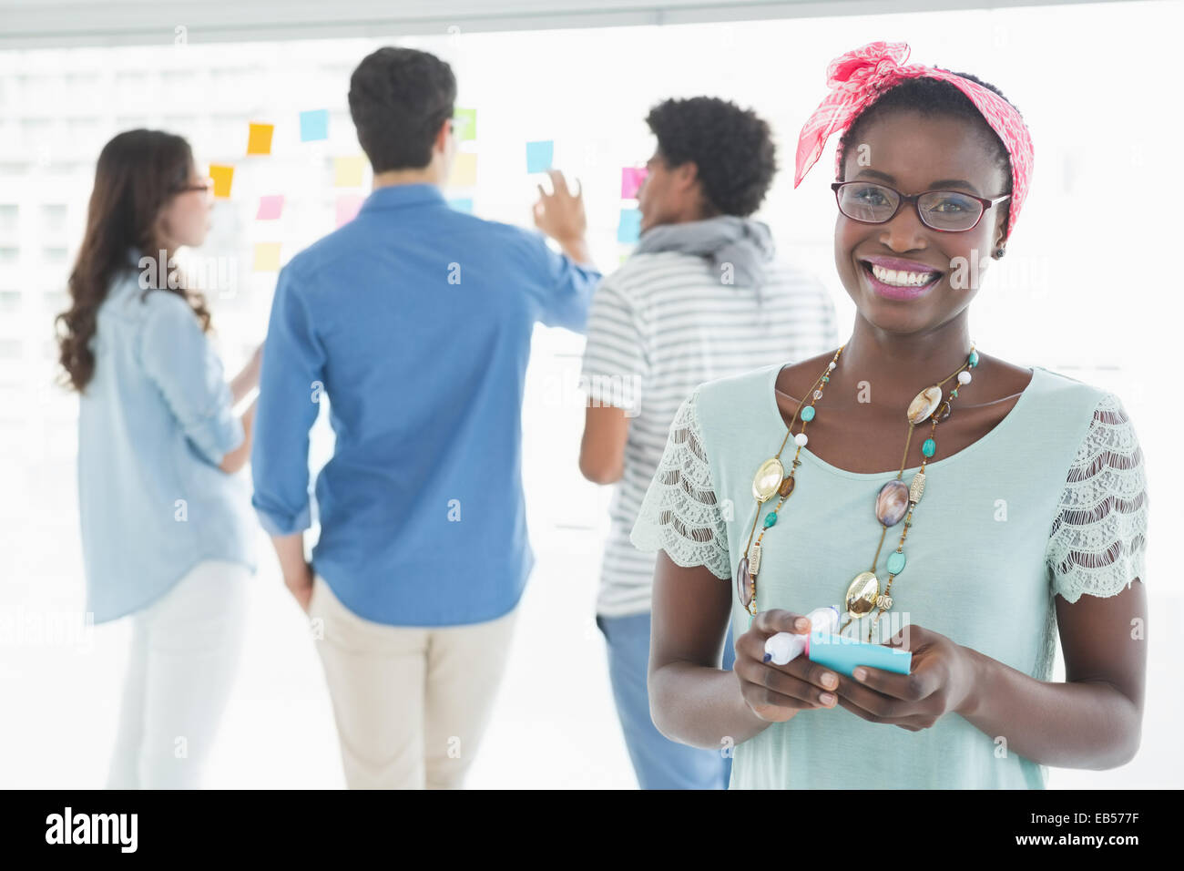 Young creative woman smiling at camera Stock Photo - Alamy