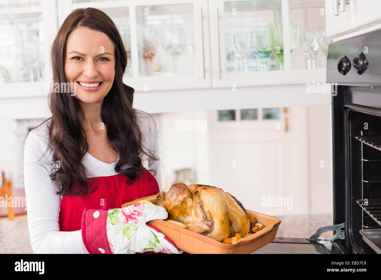 Smiling woman holding roast turkey Stock Photo - Alamy