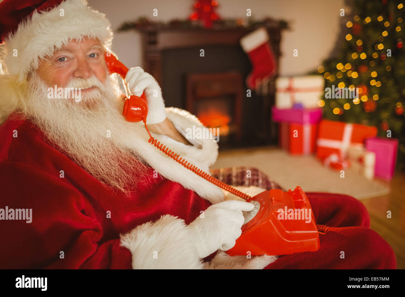 Smiling santa making a phone call Stock Photo - Alamy