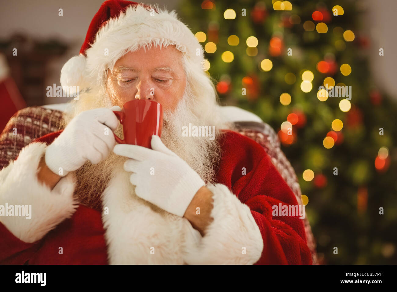 Santa claus drinking a hot beverage Stock Photo - Alamy