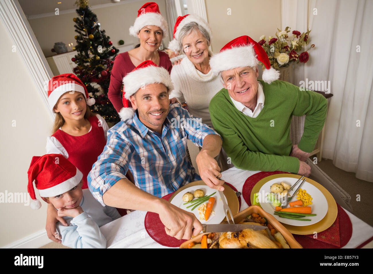 Father in santa hat carving chicken at christmas dinner Stock Photo - Alamy
