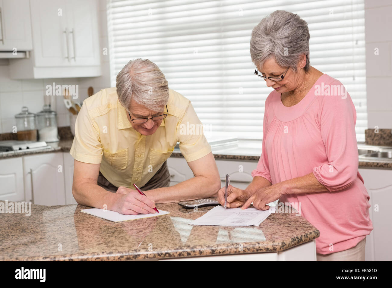 Senior happy couple counting bills hi-res stock photography and images ...