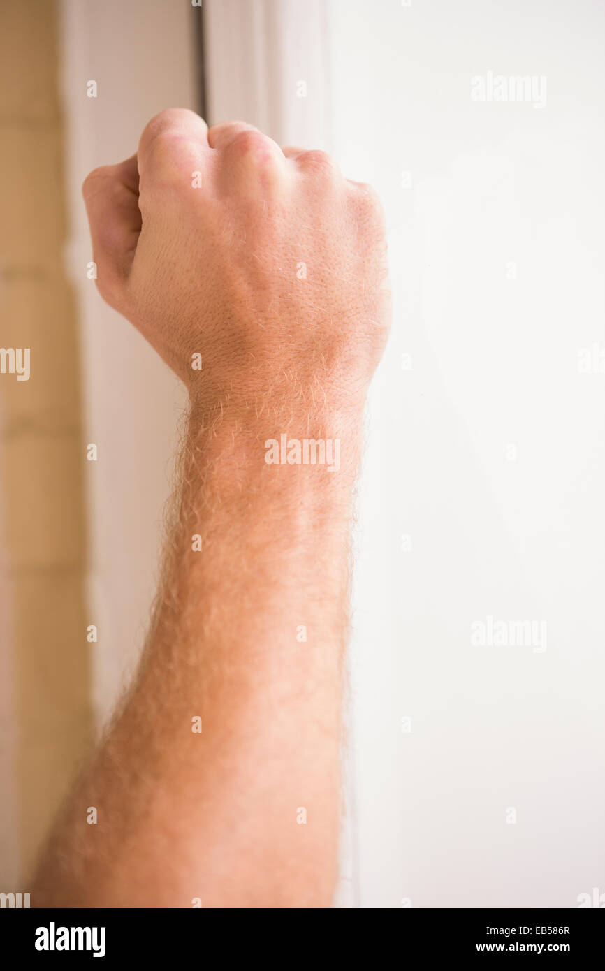 Hand knocking at the door Stock Photo - Alamy