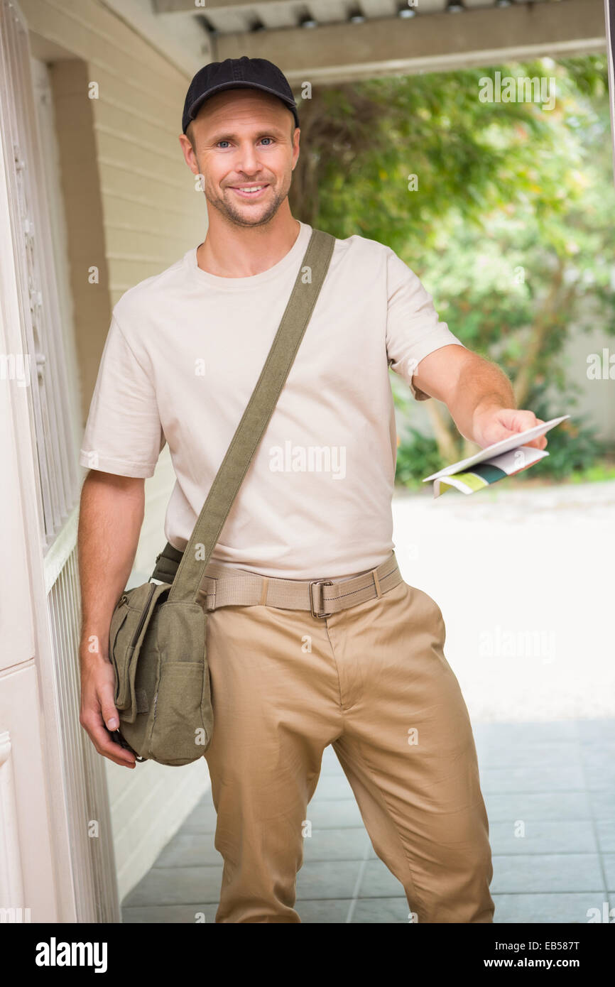 Postman delivering a letter Stock Photo - Alamy