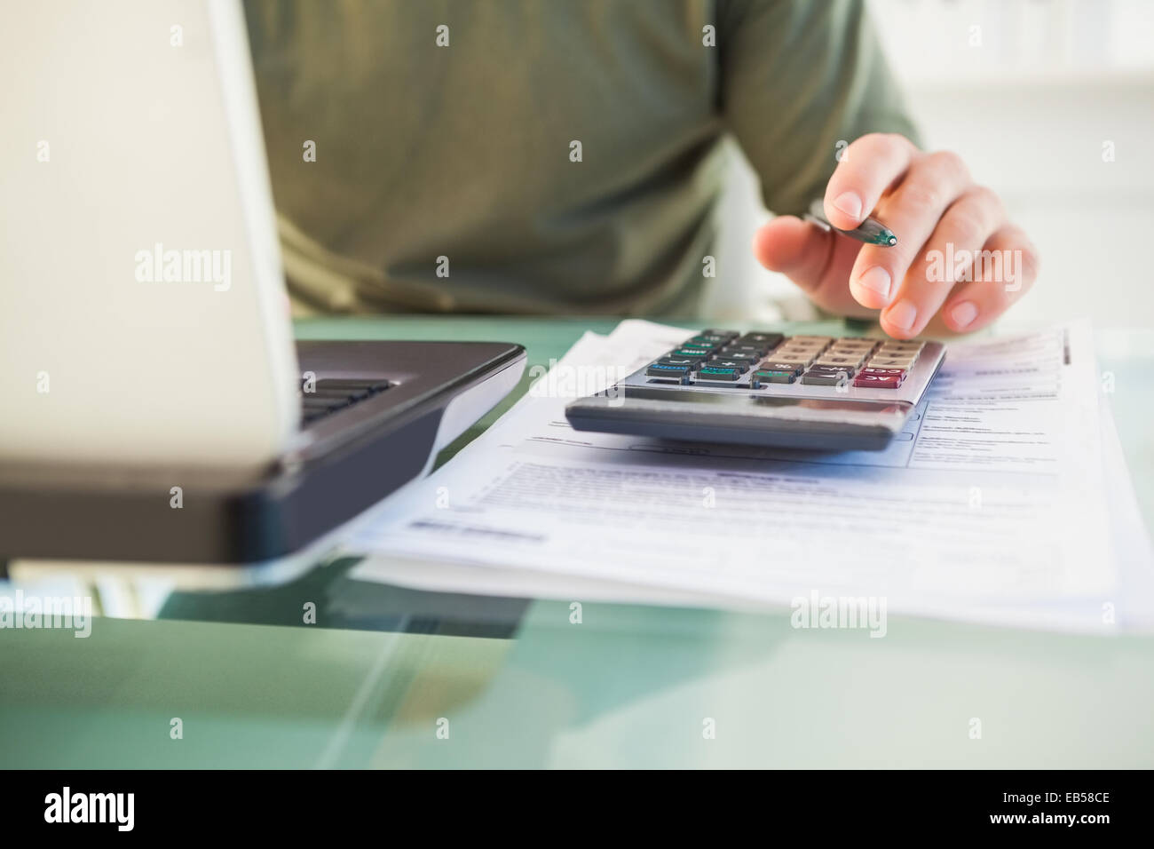 Man using laptop and calculator Stock Photo - Alamy