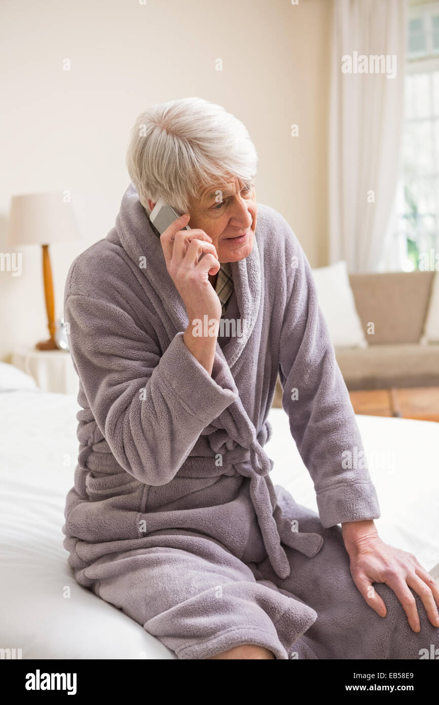 Senior man making a phone call on bed Stock Photo - Alamy
