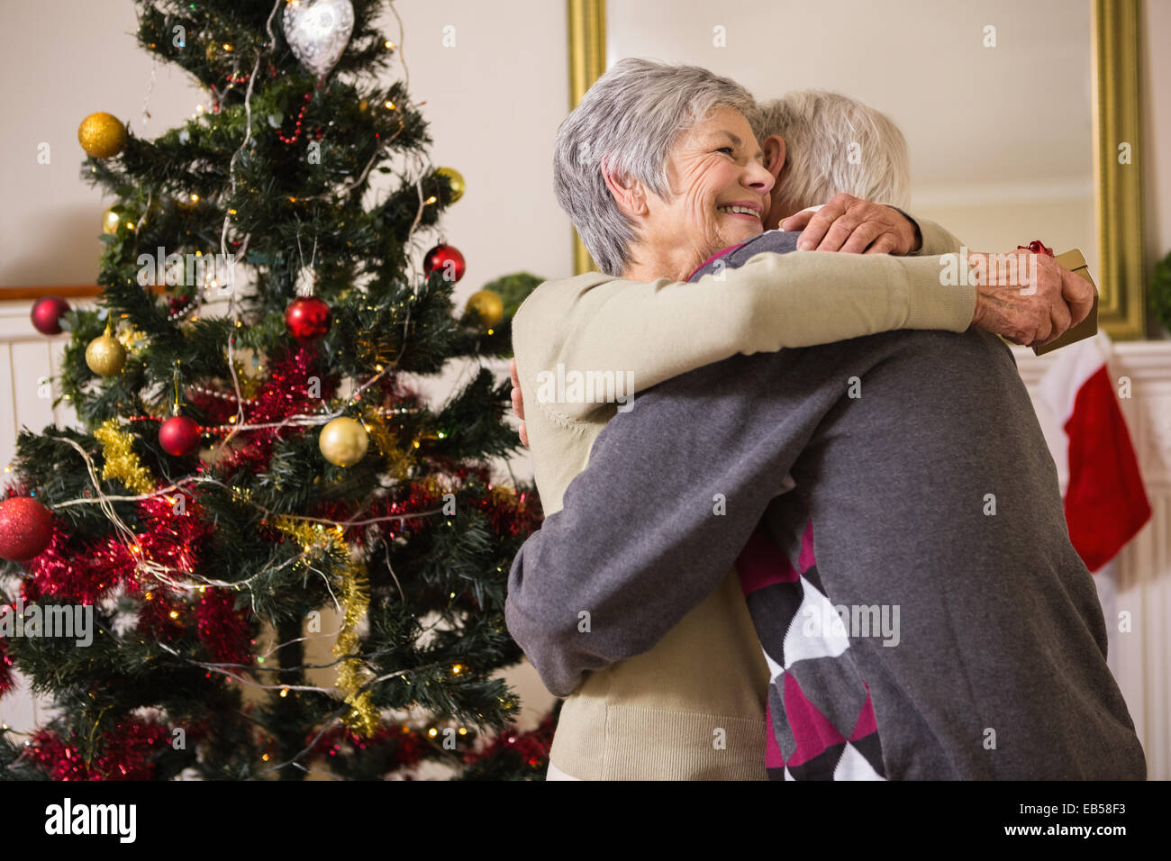 Man beside christmas tree hi-res stock photography and images - Alamy