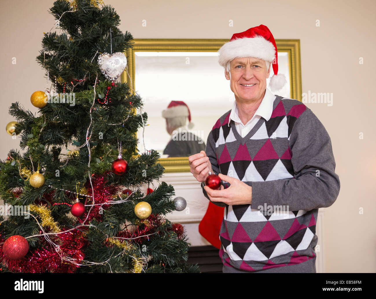 Senior man decorating the christmas tree Stock Photo - Alamy