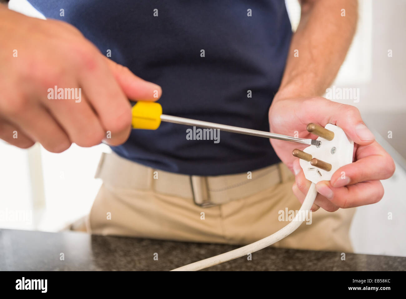 Electrician working at plug socket Stock Photo - Alamy