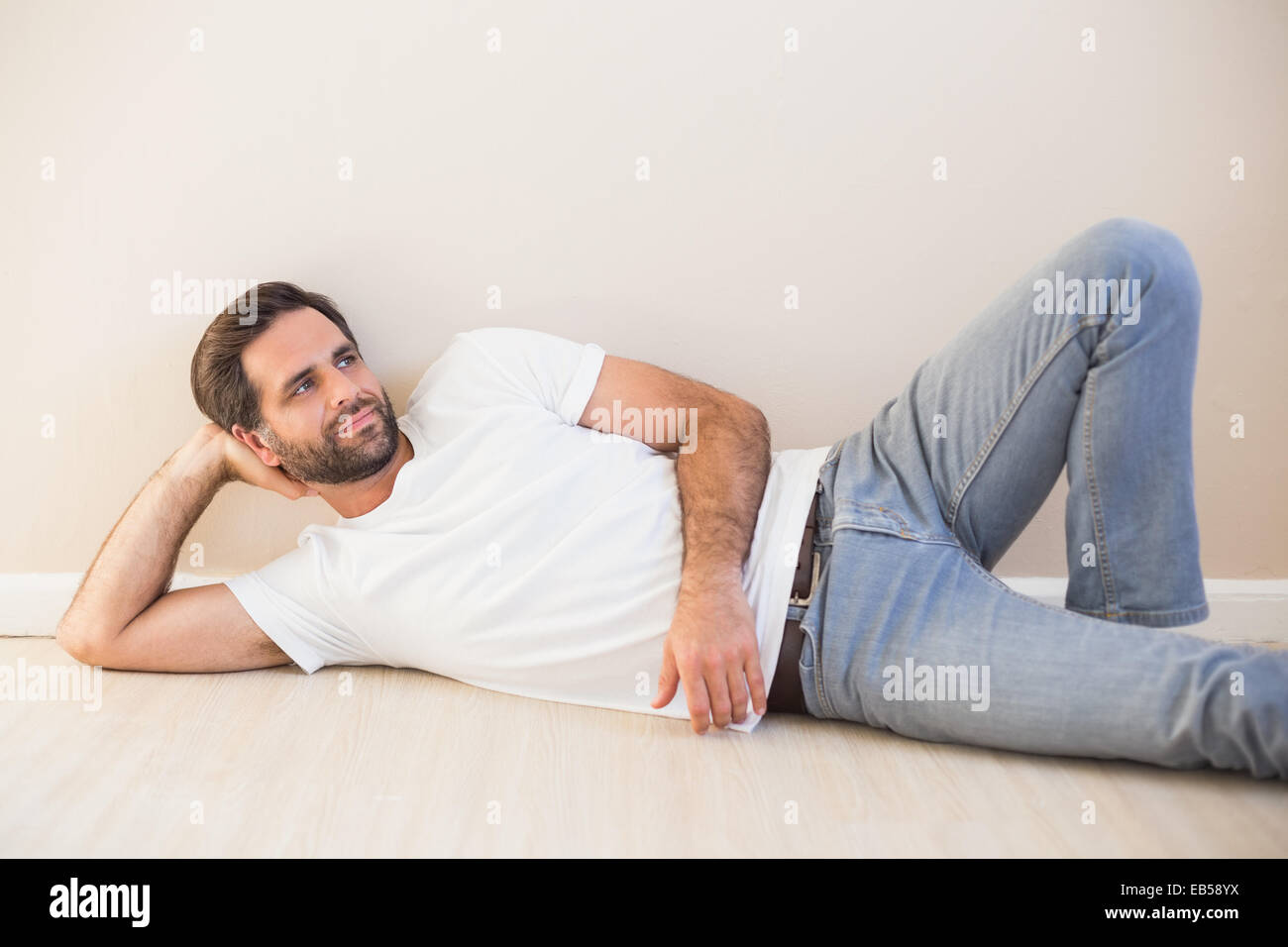 Happy man lying on the floor Stock Photo - Alamy