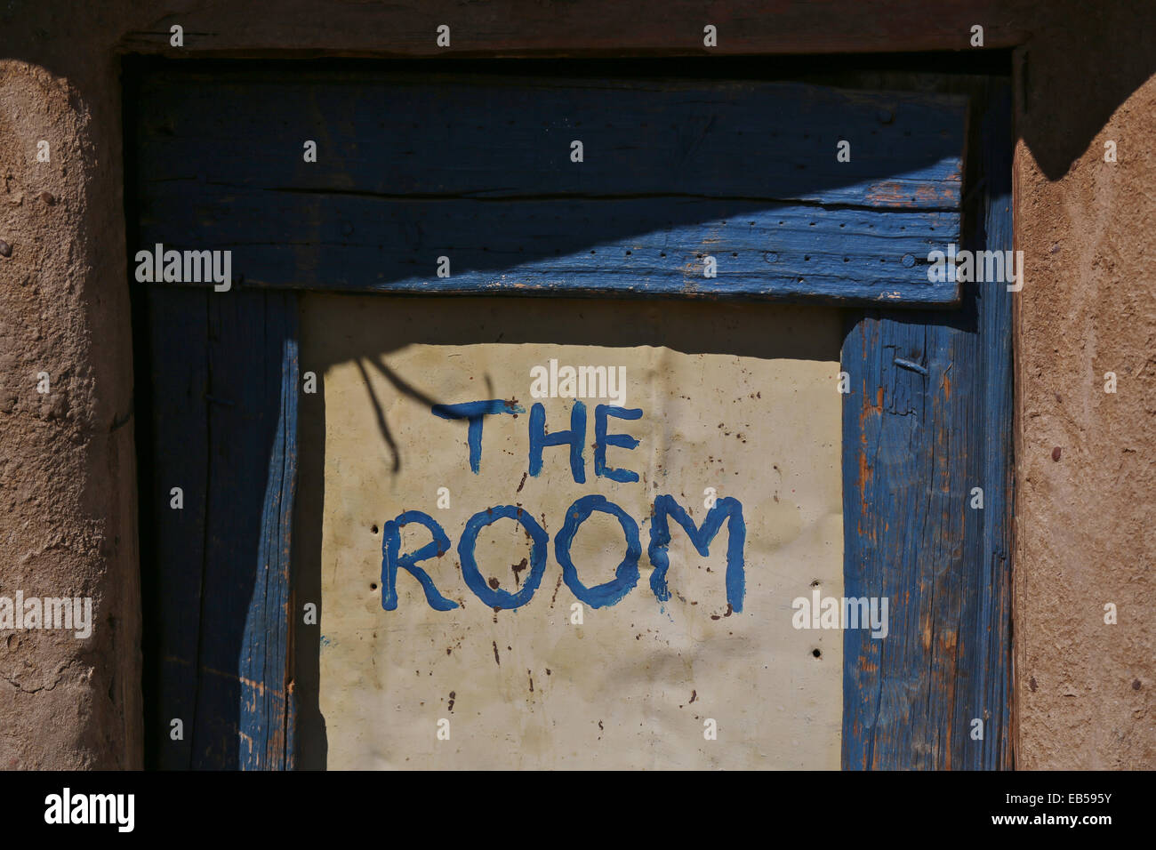 The Room, sign painted on door of mud hut on Namibian farm building ...