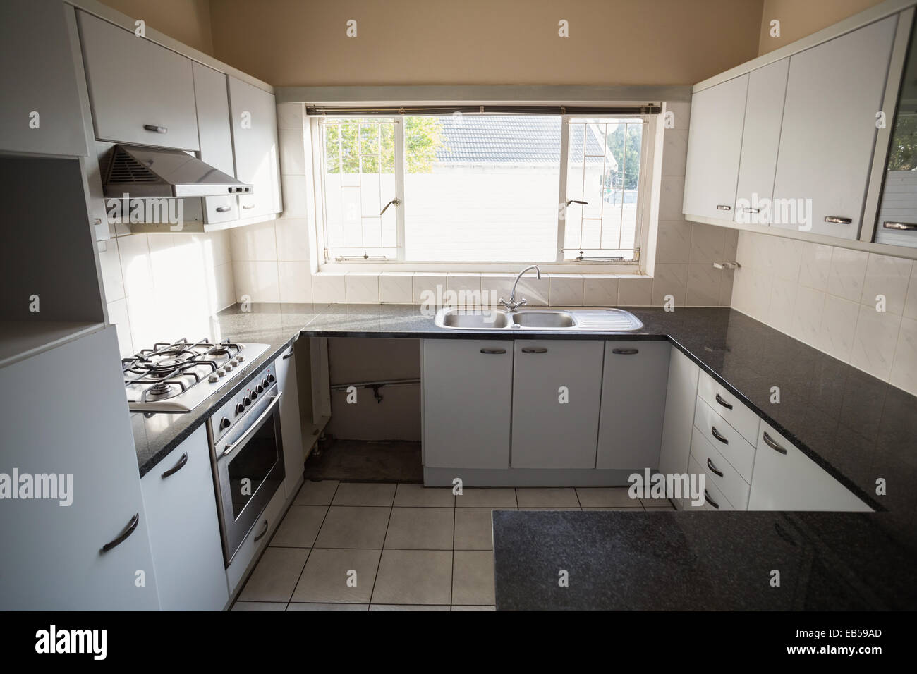Empty kitchen with white cabinets Stock Photo - Alamy