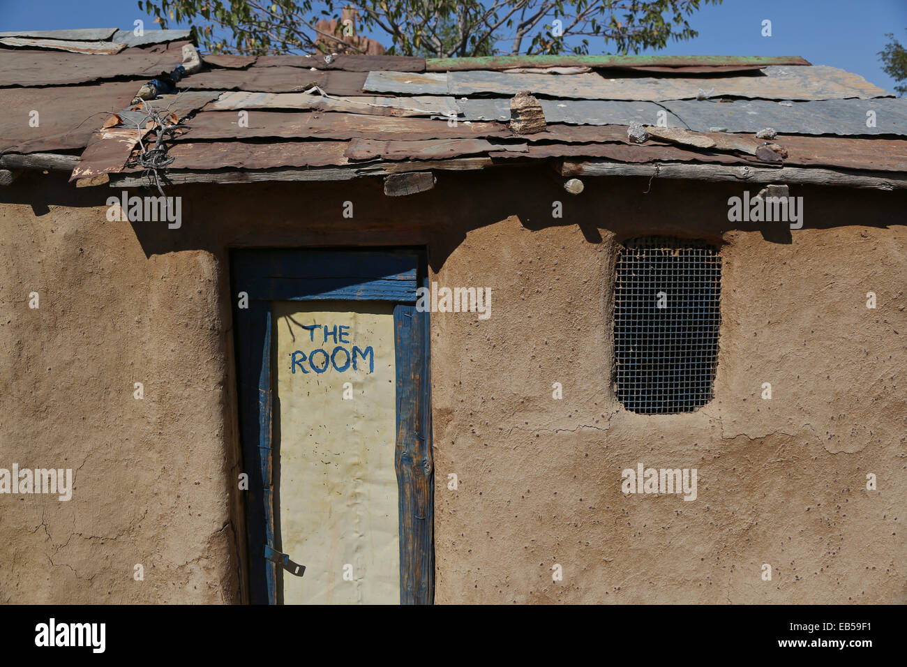 The Room, sign painted on door of mud hut on Namibian farm building ...