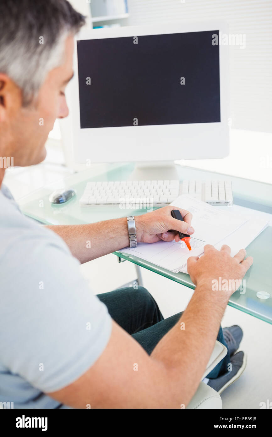 Man with highlighting information on a document Stock Photo - Alamy