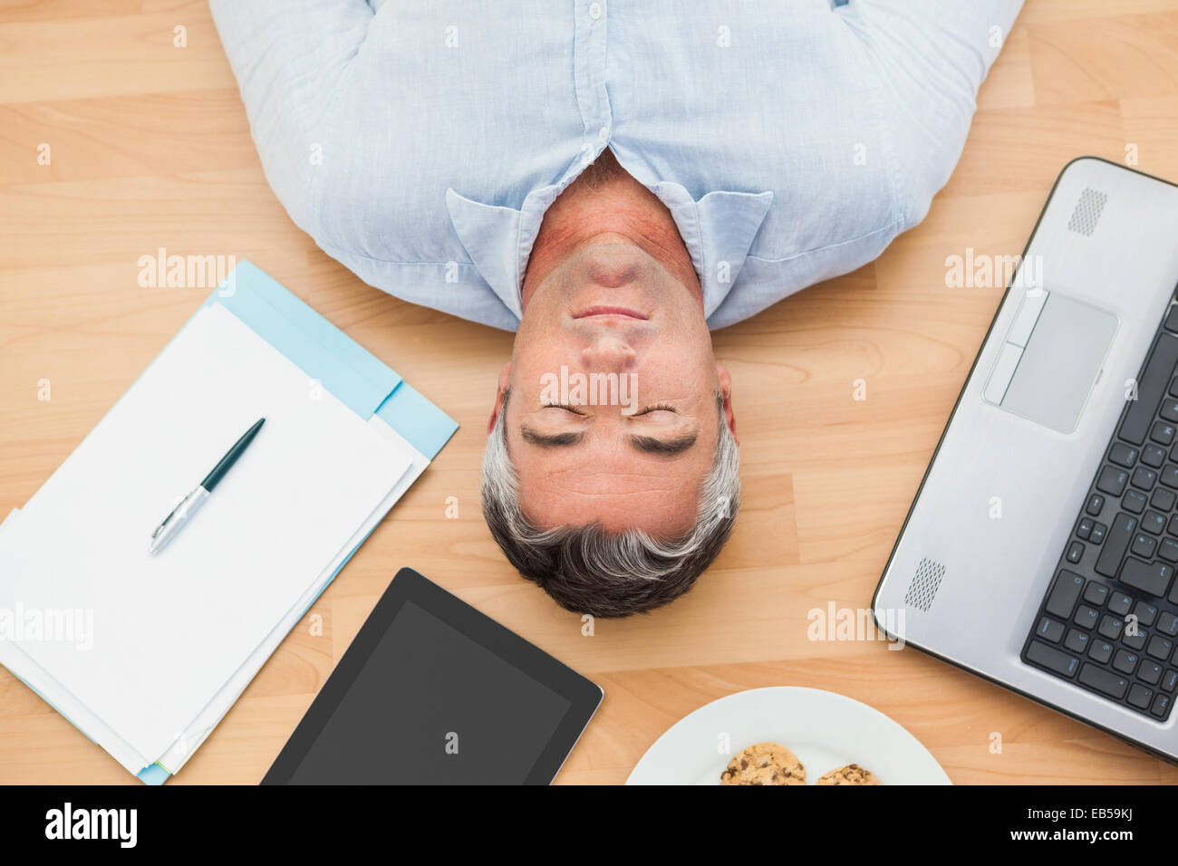 Man lying and sleeping on the floor Stock Photo - Alamy