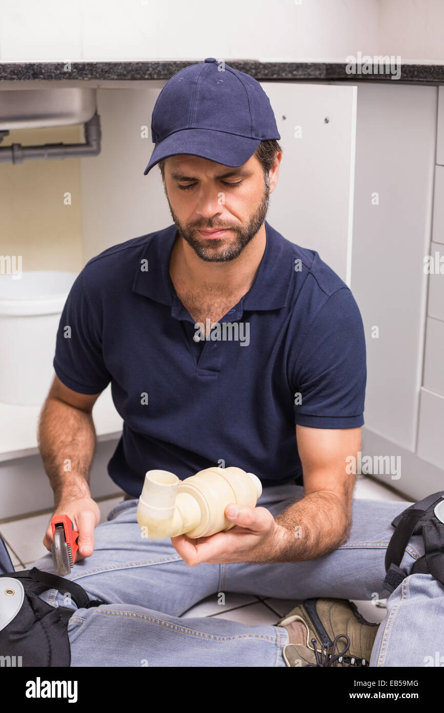 Plumber fixing under the sink Stock Photo - Alamy Plumber fixing under the sink Stock Photo - Alamy